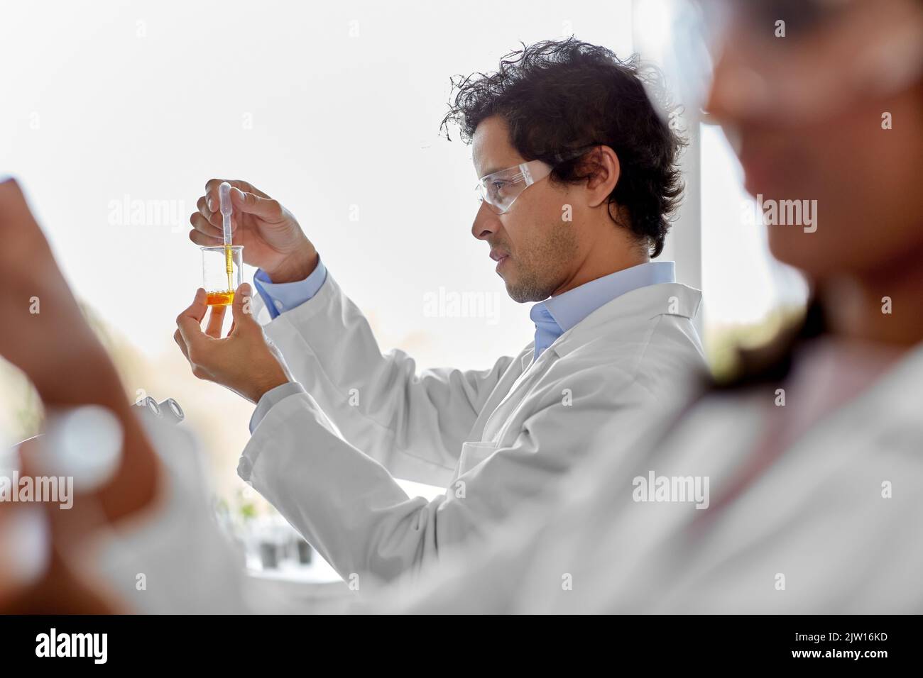 male scientist with chemical working in laboratory Stock Photo - Alamy