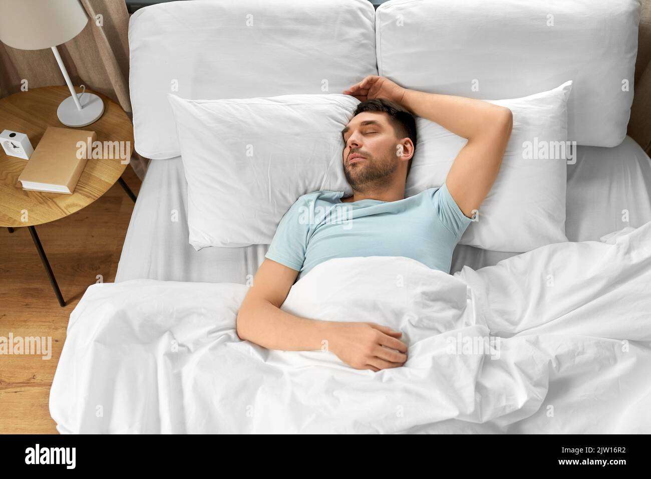 man sleeping in bed at home Stock Photo - Alamy