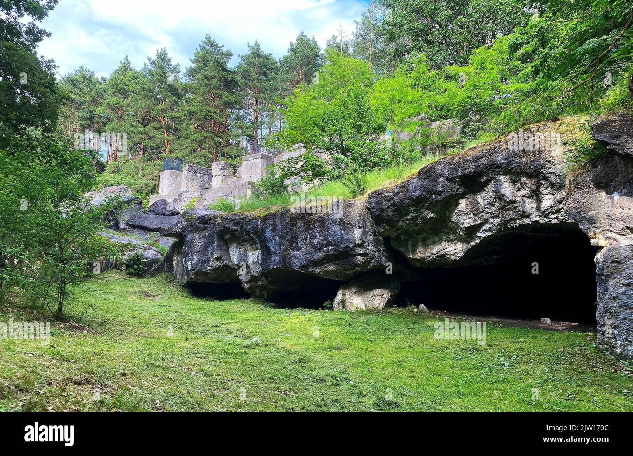 A scenery of an ancient cave settlement in the forest Stock Photo - Alamy