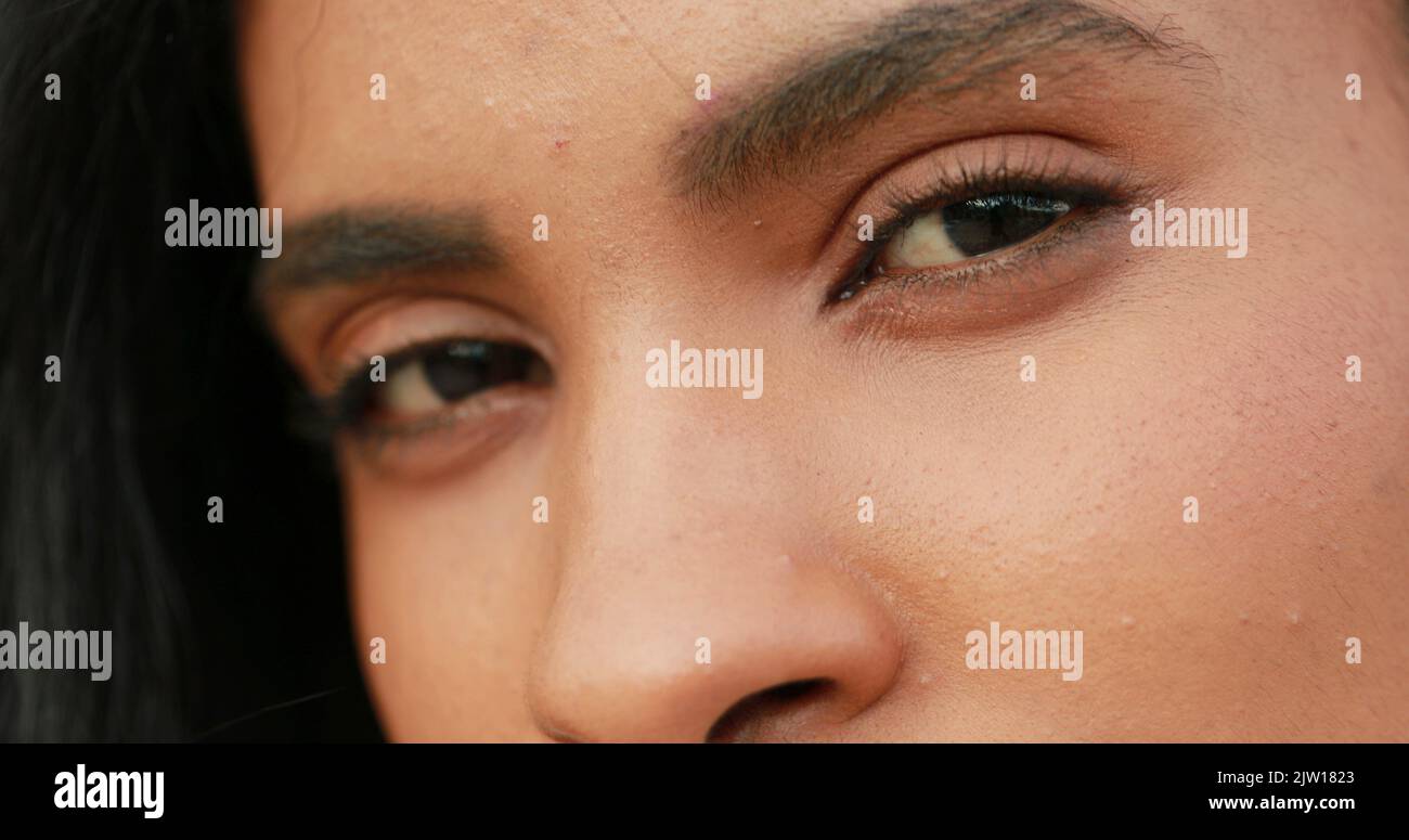 African woman opening eyes, macro closeup of young black girl eyes ...