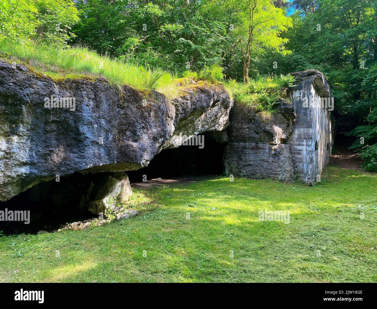 A scenery of an ancient cave settlement in the forest Stock Photo - Alamy