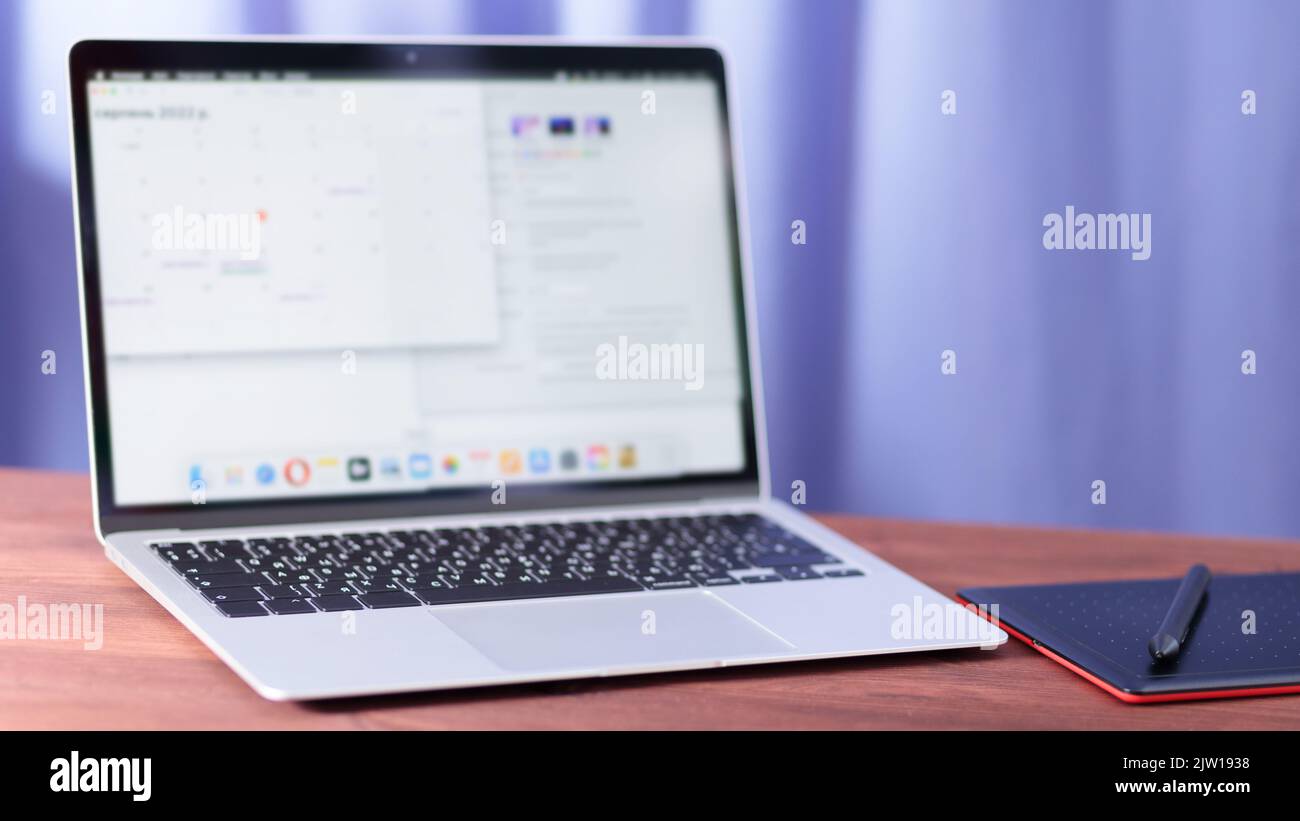 Graphic designer's workplace. Laptop and graphics tablet on a wooden ...