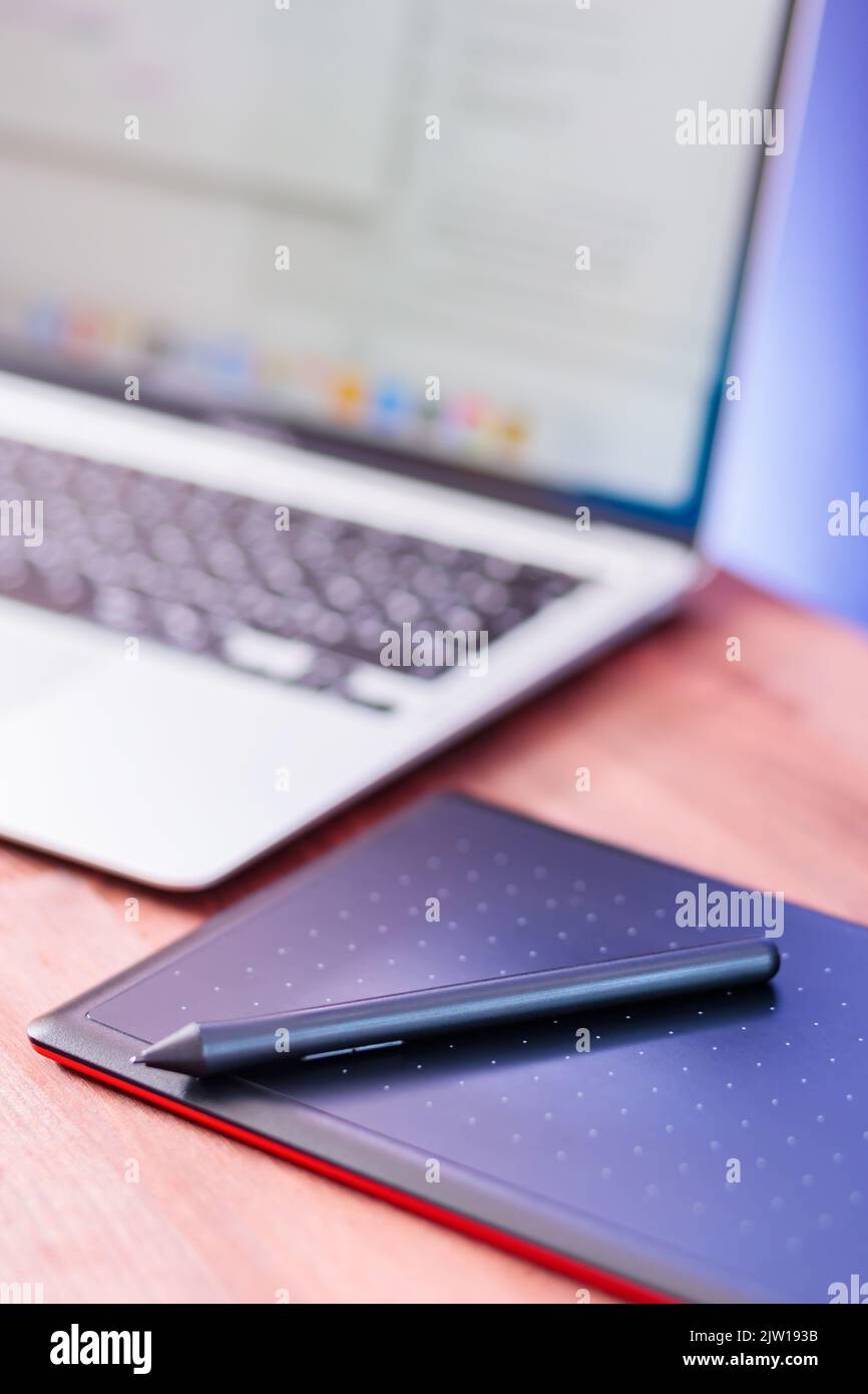 Graphic designer's workplace. Laptop and graphics tablet on a wooden ...