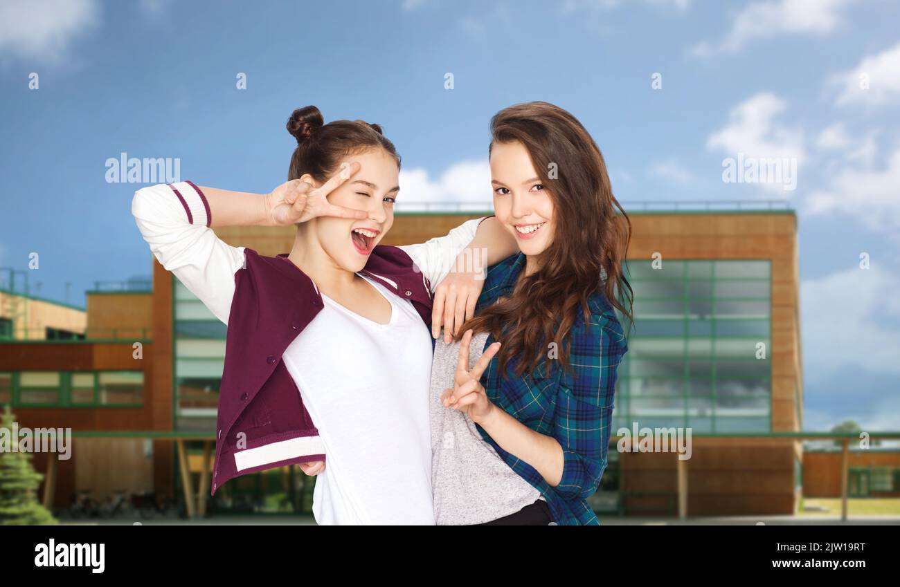 happy pretty teenage girls showing peace hand sign Stock Photo - Alamy