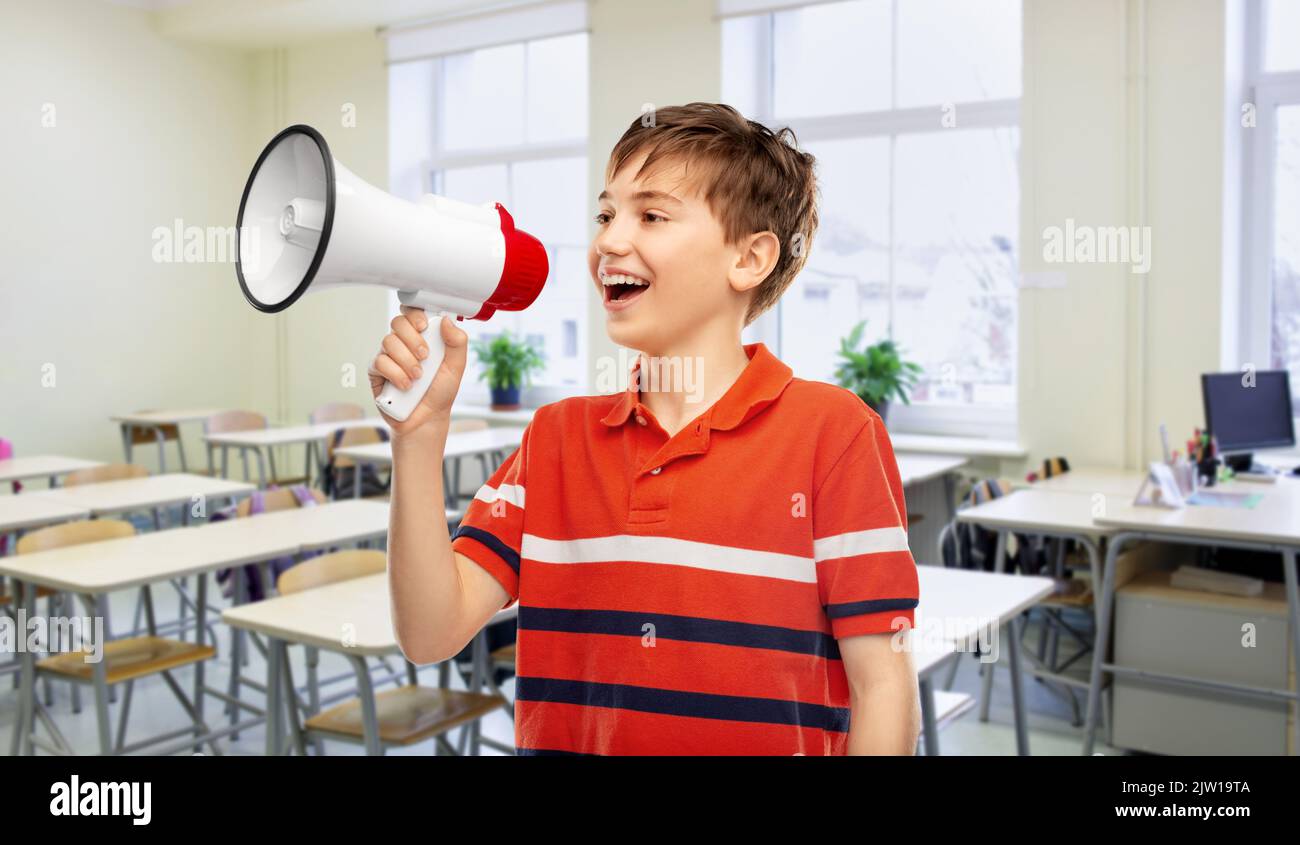 student boy speaking to megaphone at school Stock Photo - Alamy
