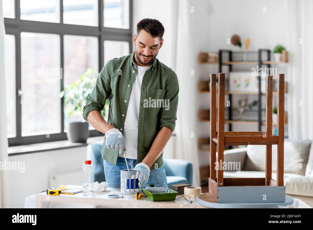 man stirring can with grey color paint at home Stock Photo - Alamy