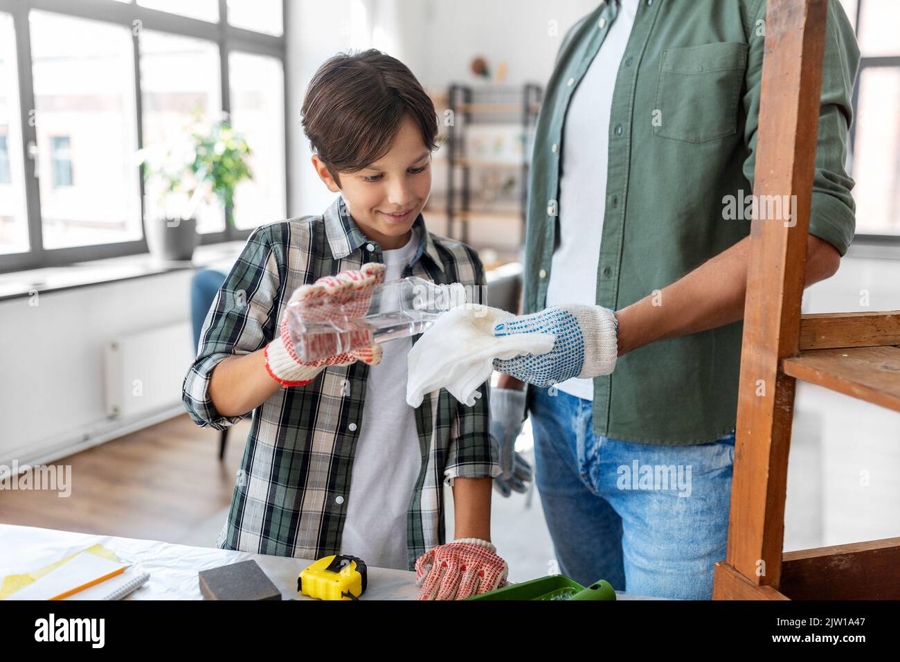 father and son applying solvent to tissue at home Stock Photo - Alamy