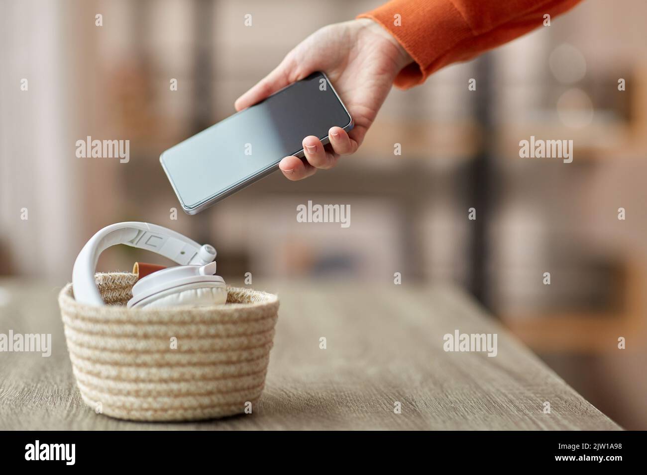 hand holding smartphone and gadgets in basket Stock Photo - Alamy