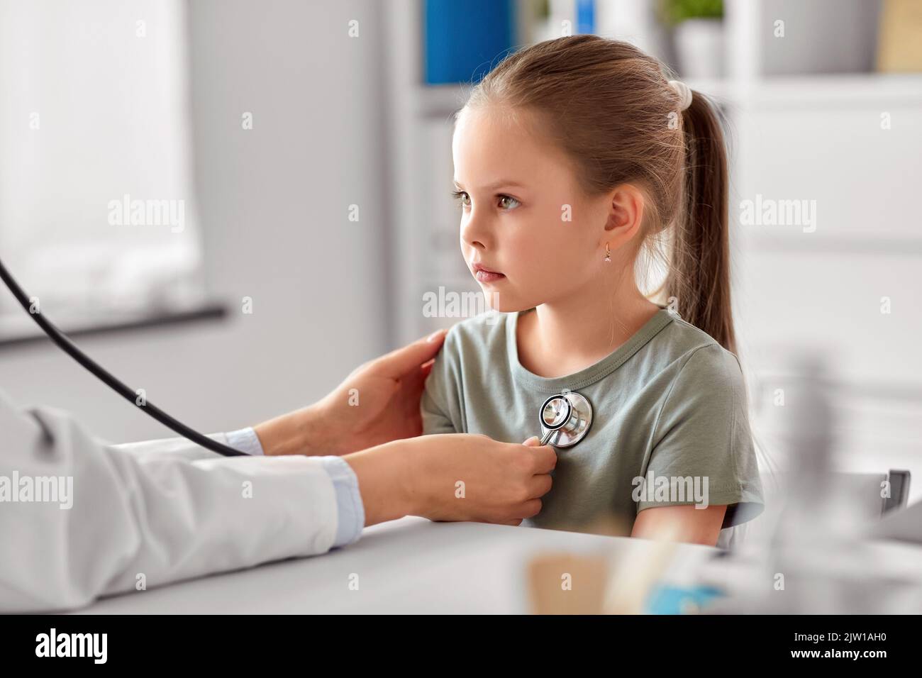 doctor with stethoscope and girl patient at clinic Stock Photo - Alamy