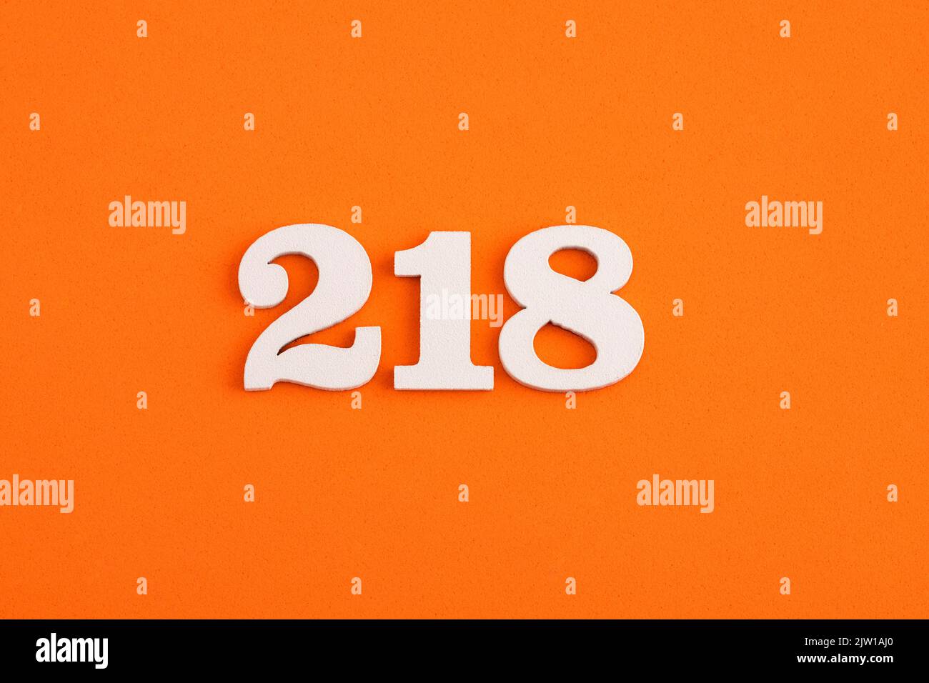 White wooden number 218 on eva rubber orange background Stock Photo - Alamy