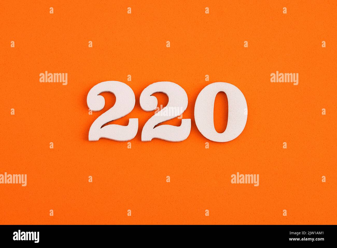 White wooden number 220 on eva rubber orange background Stock Photo - Alamy