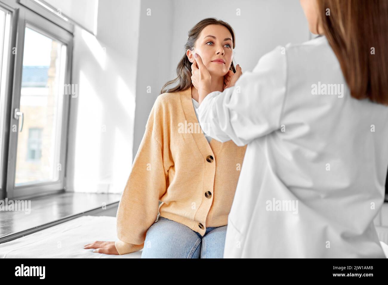doctor checking lymph nodes of woman at hospital Stock Photo - Alamy