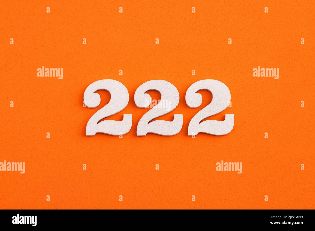 White wooden number 222 on eva rubber orange background Stock Photo - Alamy