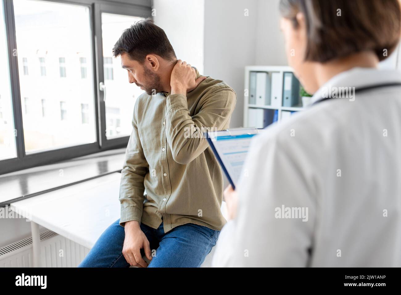 patient with pain in neck and doctor at hospital Stock Photo - Alamy
