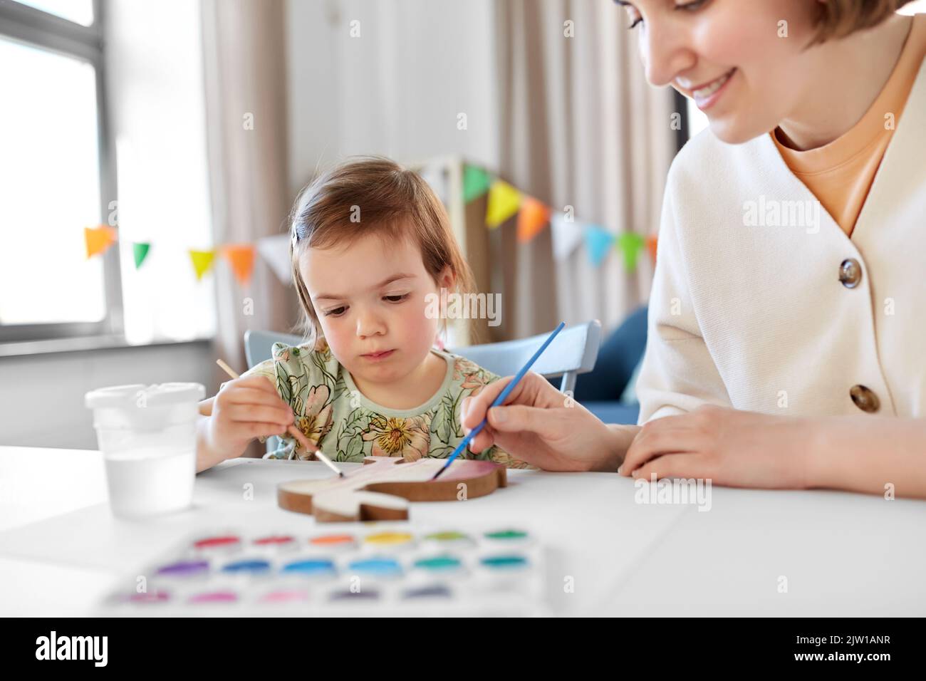 mother with child coloring easter bunny at home Stock Photo - Alamy