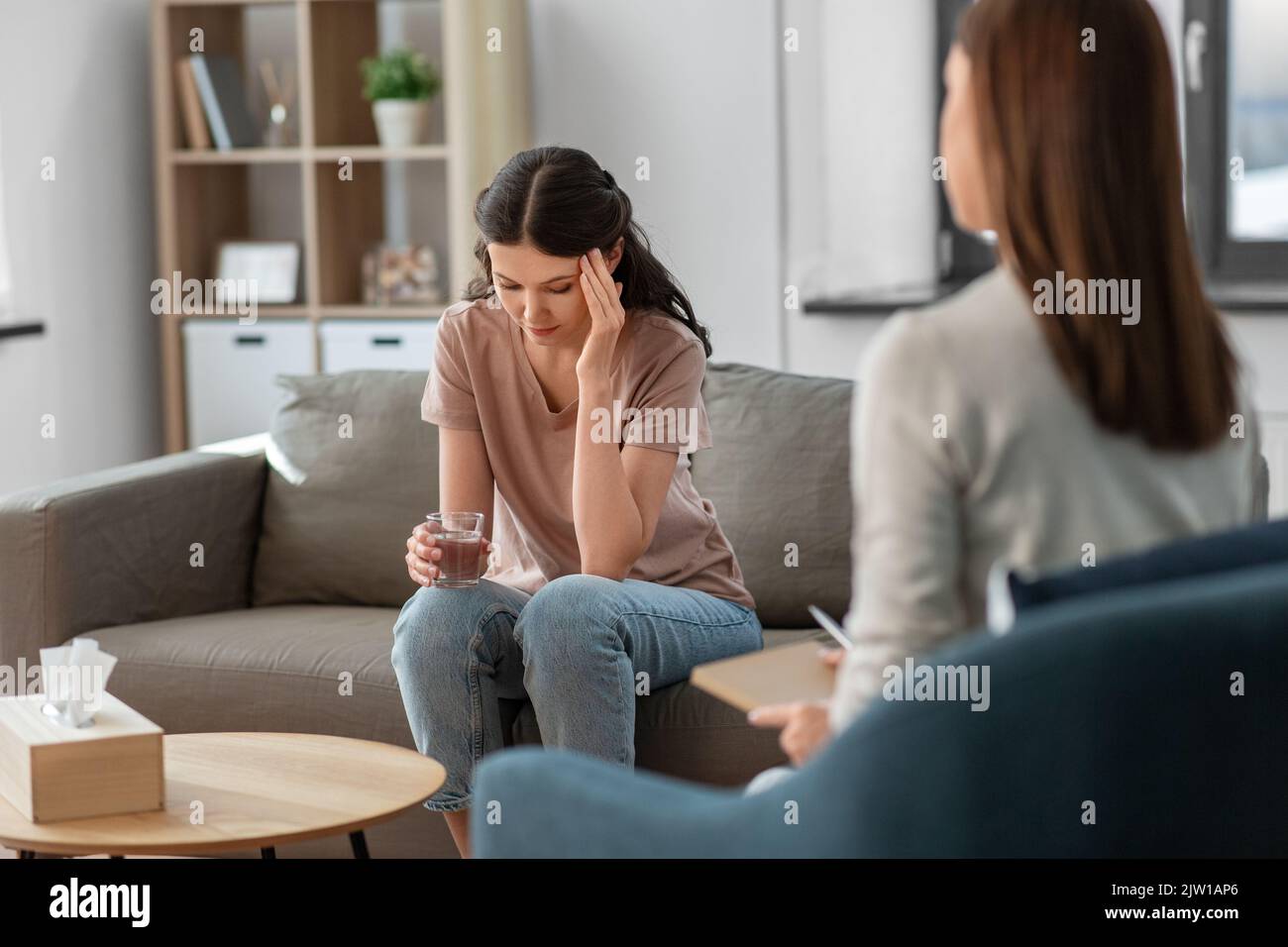 Female doctor drinking water hi-res stock photography and images - Alamy