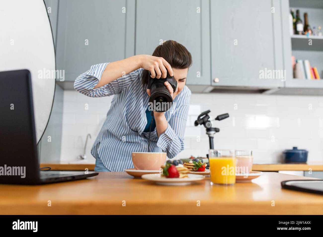 food photographer with camera working in kitchen Stock Photo - Alamy