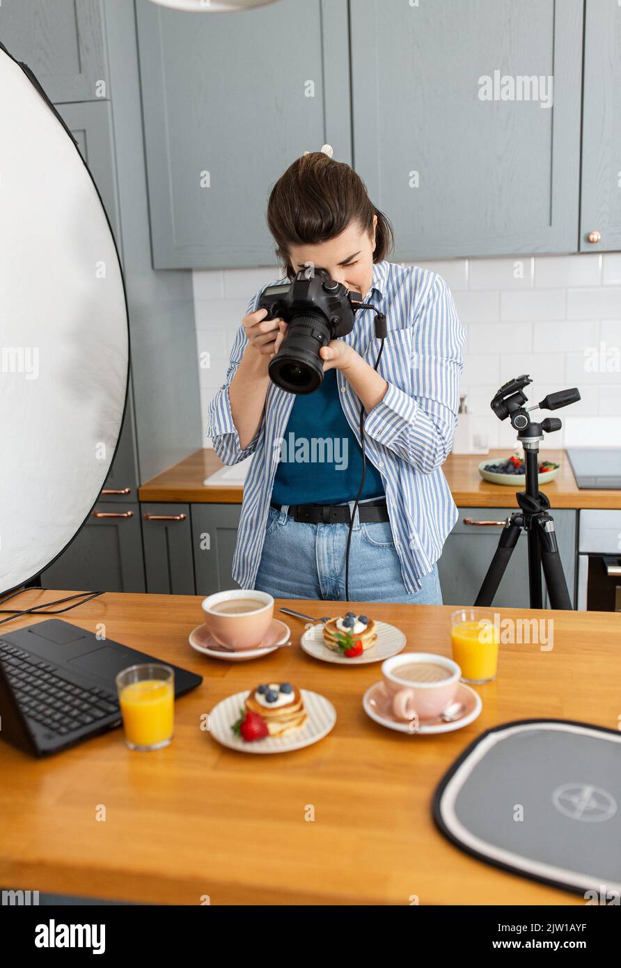 food photographer with camera working in kitchen Stock Photo - Alamy