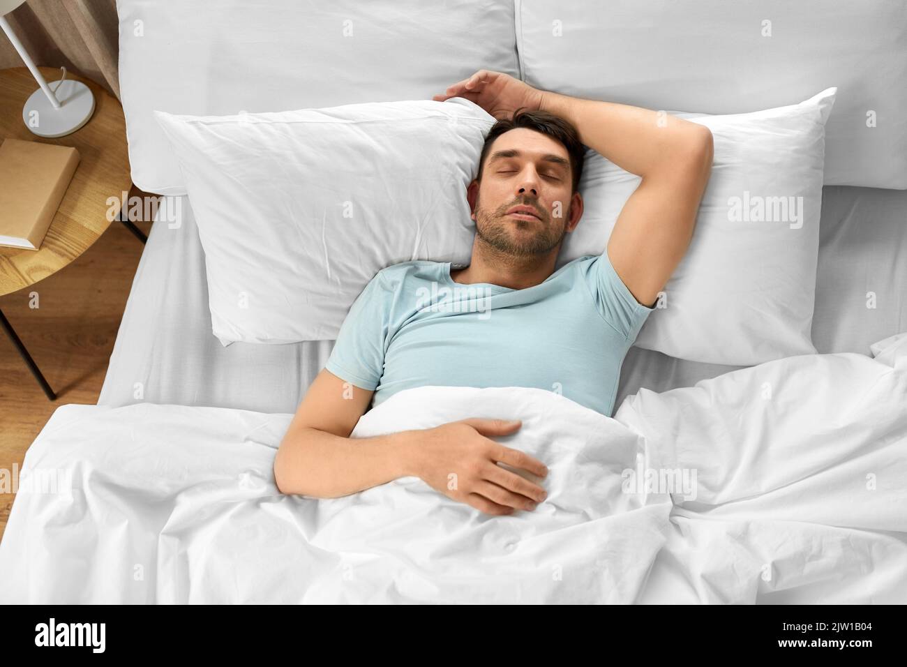 man sleeping in bed at home Stock Photo - Alamy