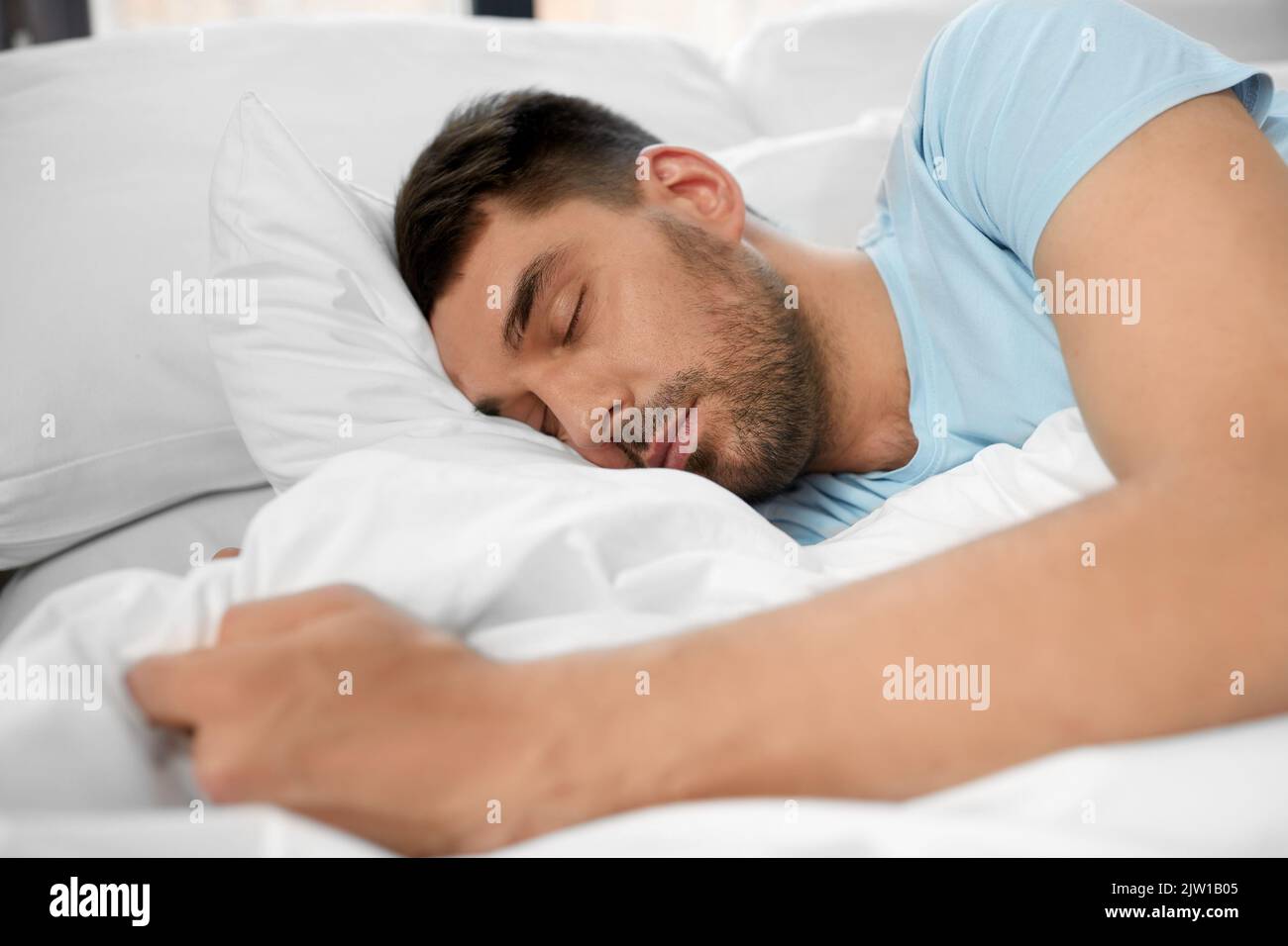 man sleeping in bed at home Stock Photo - Alamy