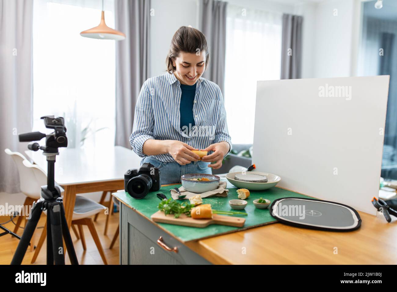 food photographer with camera working in kitchen Stock Photo - Alamy