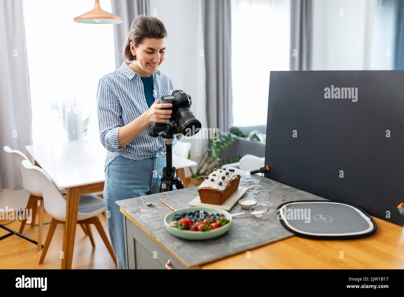 food photographer with camera working in kitchen Stock Photo - Alamy
