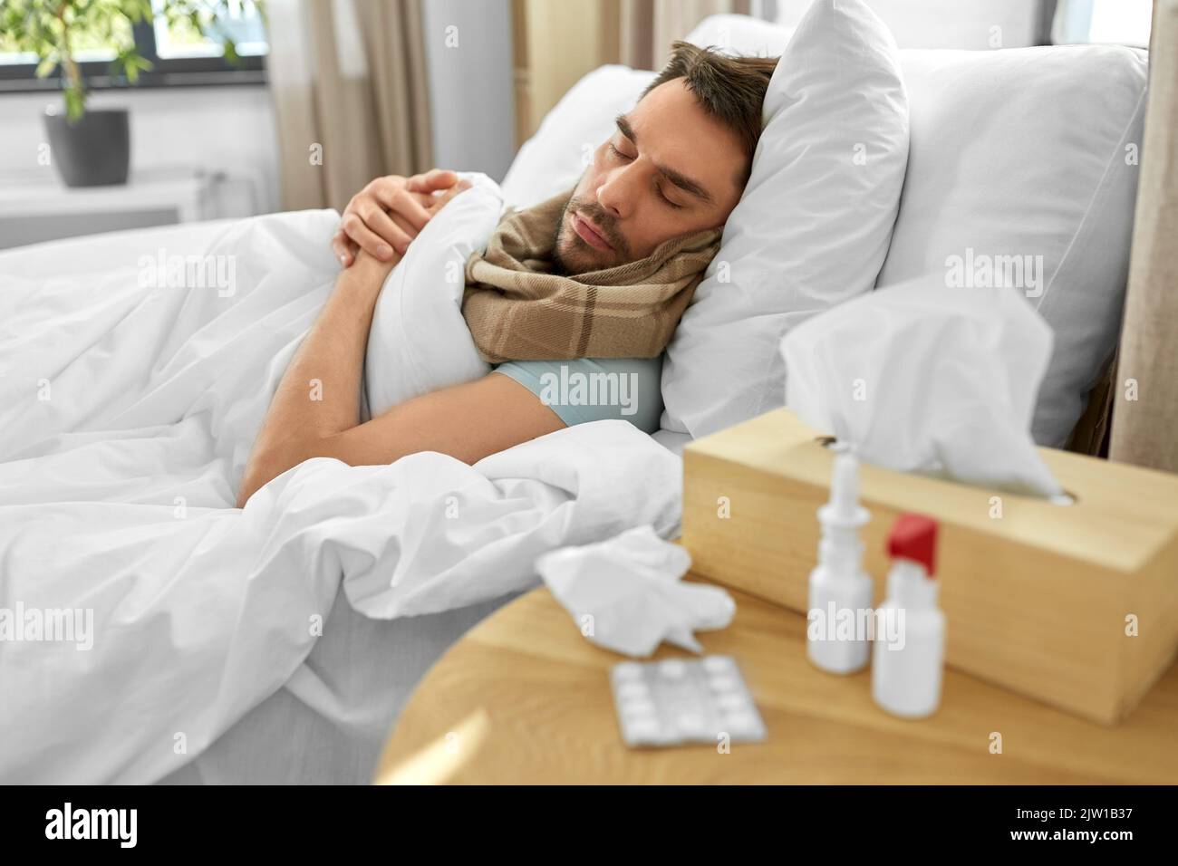 sick man with medicines on table sleeping in bed Stock Photo - Alamy