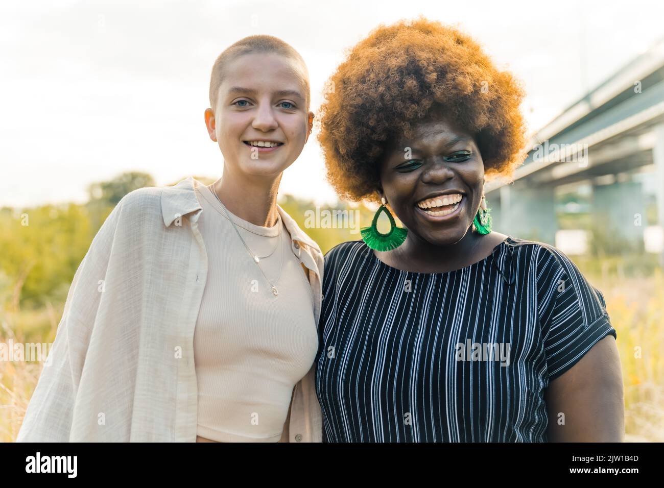 Close interracial friendship. Delighted happy mixed race girls smiling ...