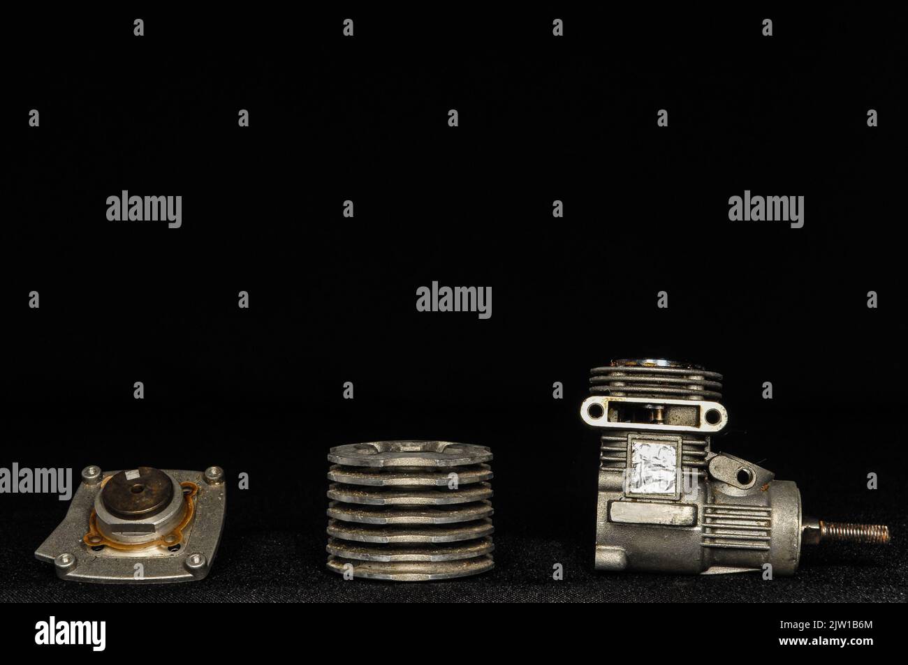 A closeup of components of a modern car engine isolated on a black ...