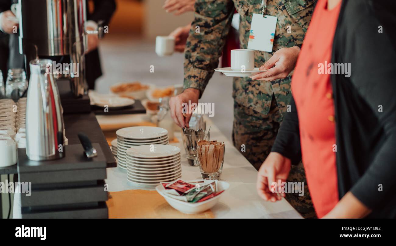 Close-up photo of soldier serving themselves in a modern hotel during a ...