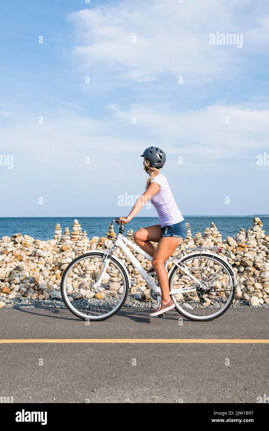 Young Woman biking by Cape Cod beaches coastal bike path Stock Photo ...