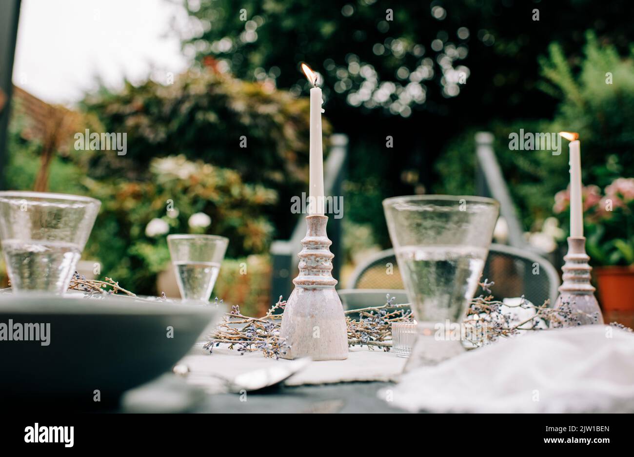 candle stick burning on a decorated dinner table Stock Photo - Alamy