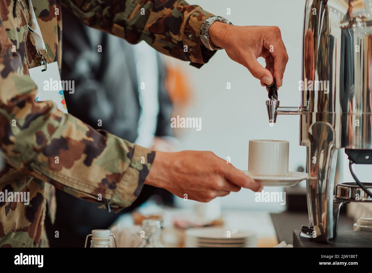 Close-up photo of soldier serving themselves in a modern hotel during a ...