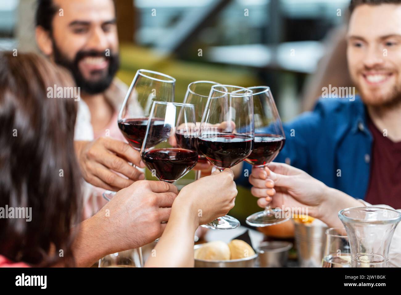 happy friends drinking red wine at restaurant Stock Photo - Alamy
