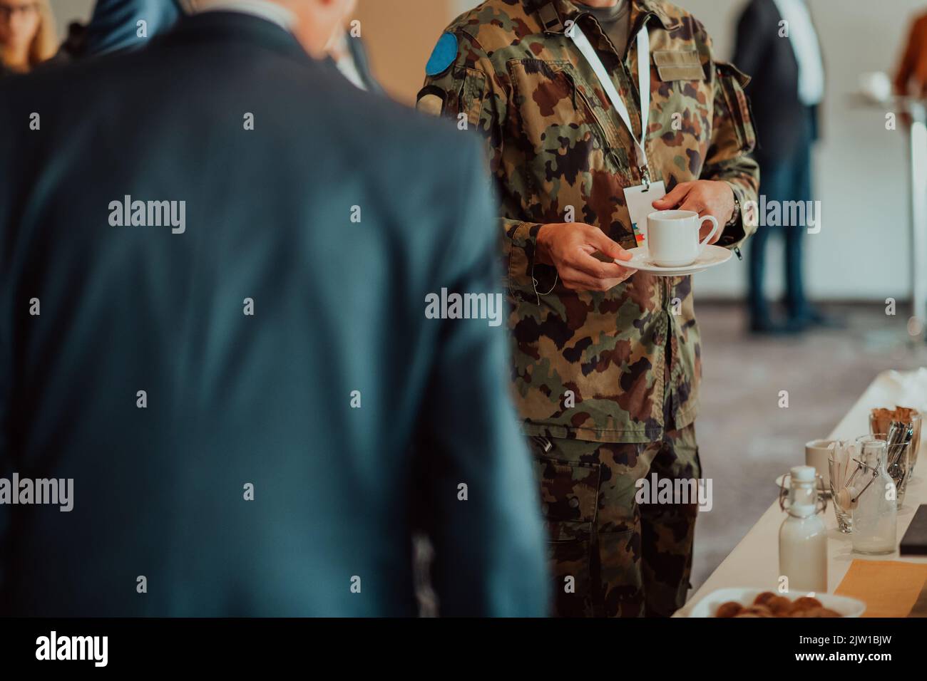 Close-up photo of soldier serving themselves in a modern hotel during a ...