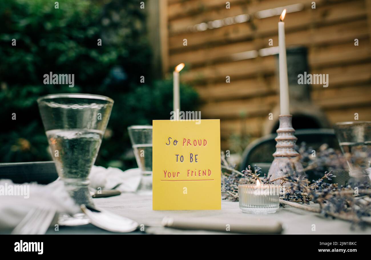 card celebrating friendship on a decorated dinner table Stock Photo - Alamy