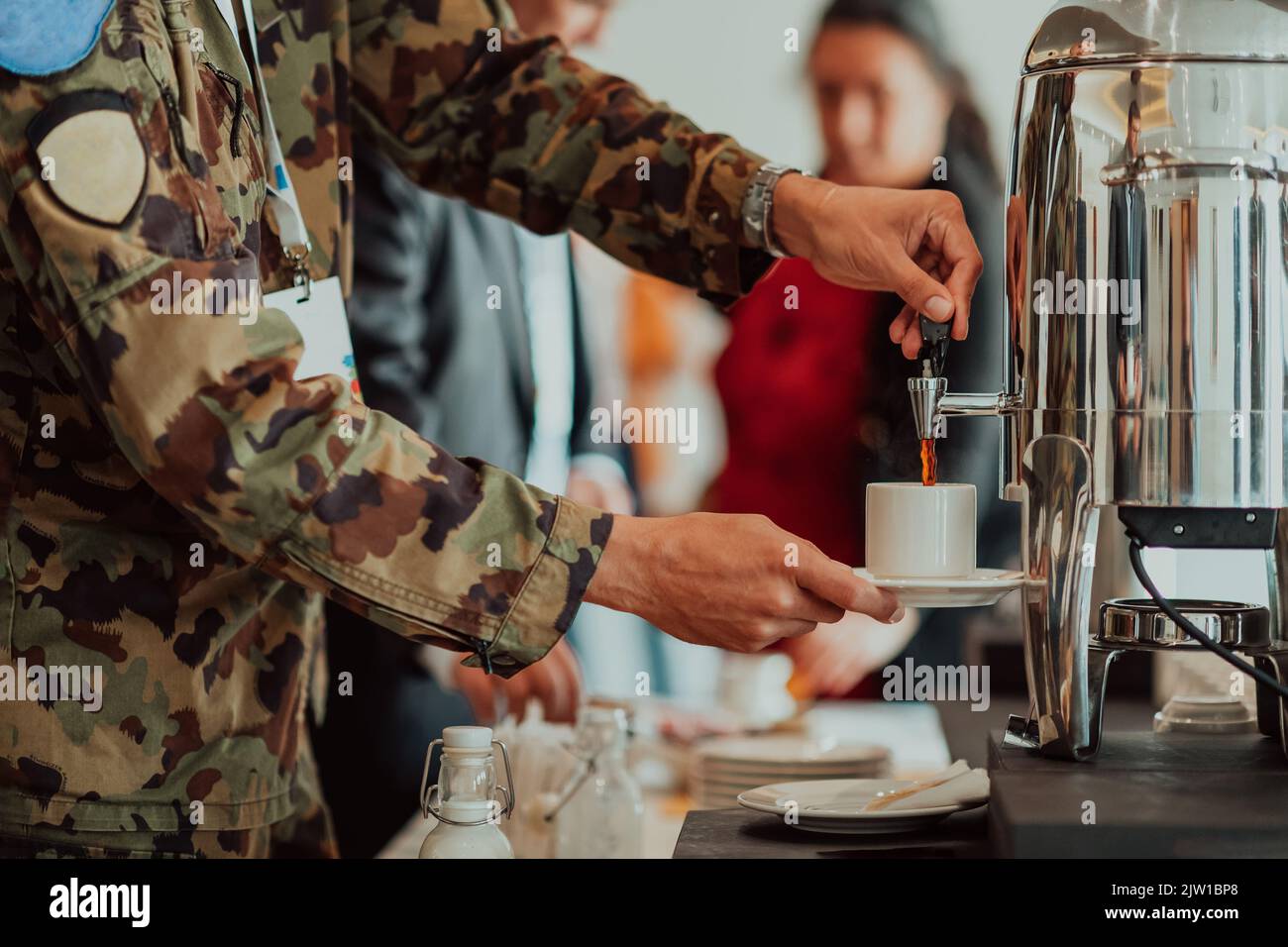 Close-up photo of soldier serving themselves in a modern hotel during a ...