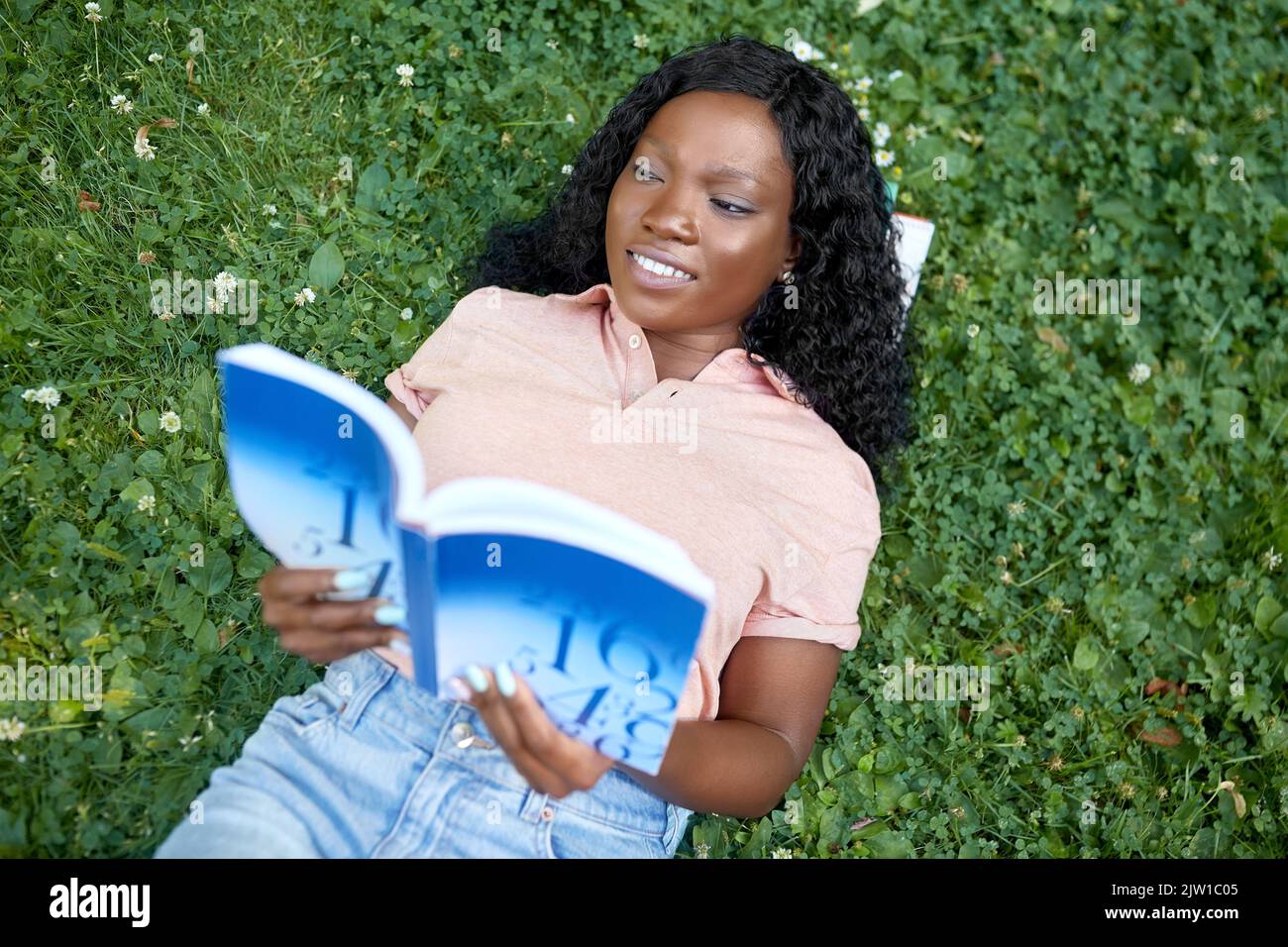 african student girl reading math textbook Stock Photo - Alamy