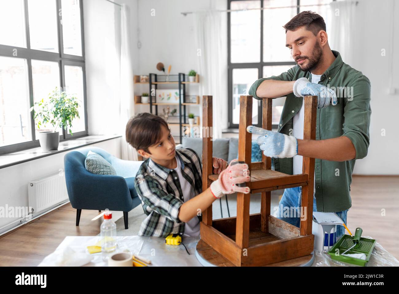father and son sanding old table with sponge Stock Photo - Alamy
