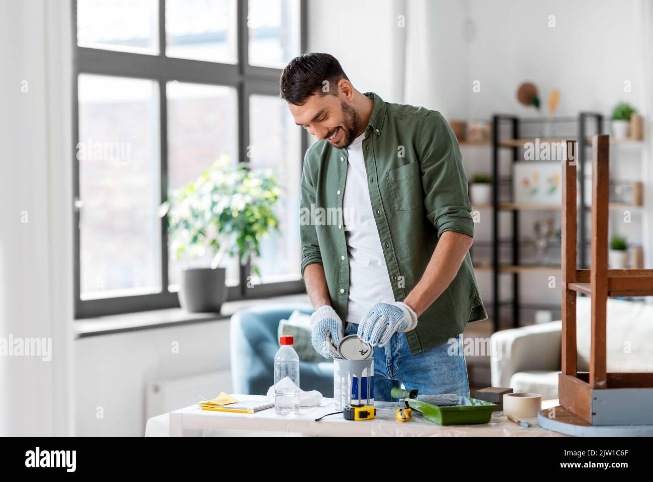 man opening can with grey color at home Stock Photo - Alamy