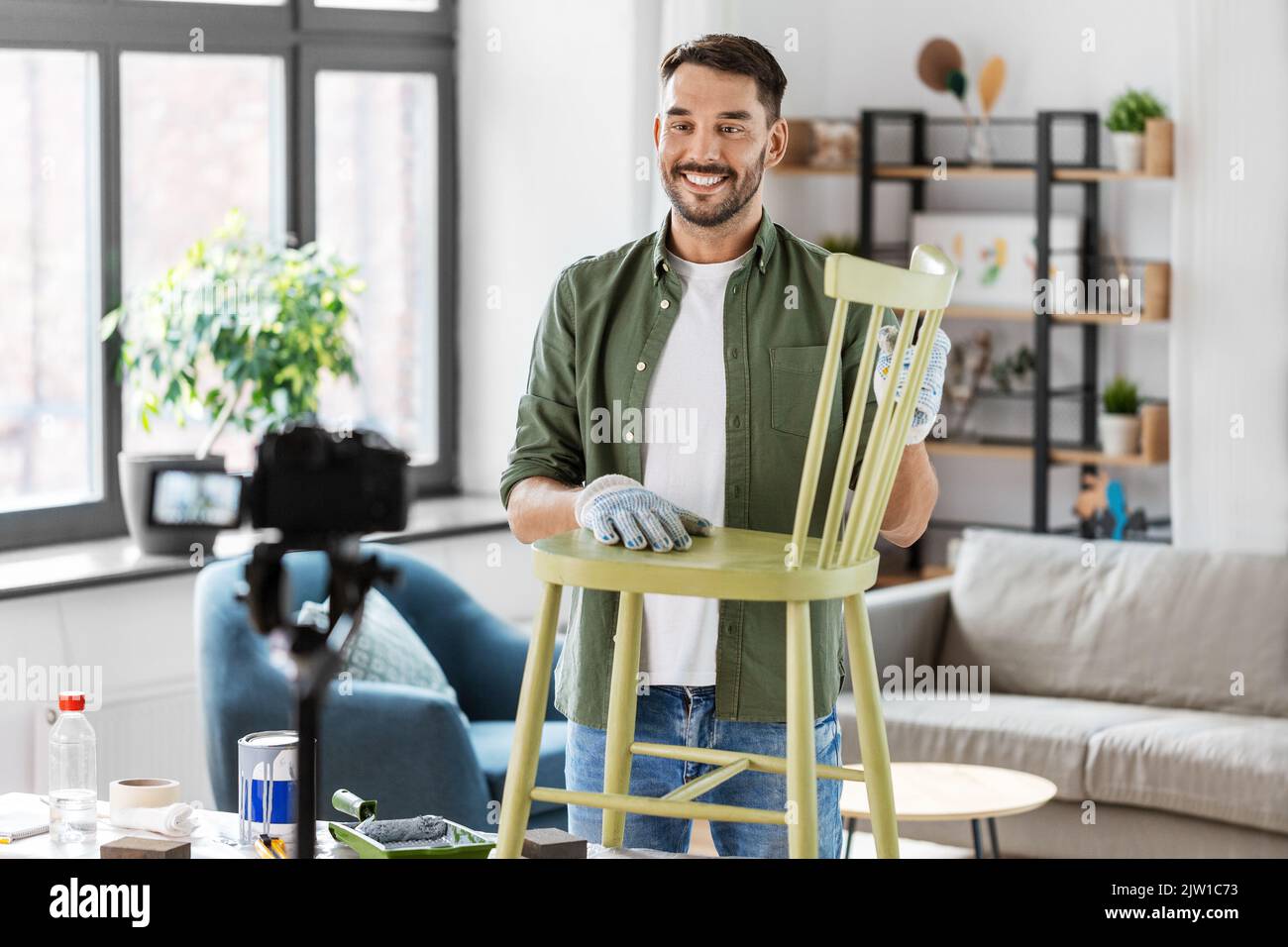man or blogger showing old chair renovation Stock Photo - Alamy