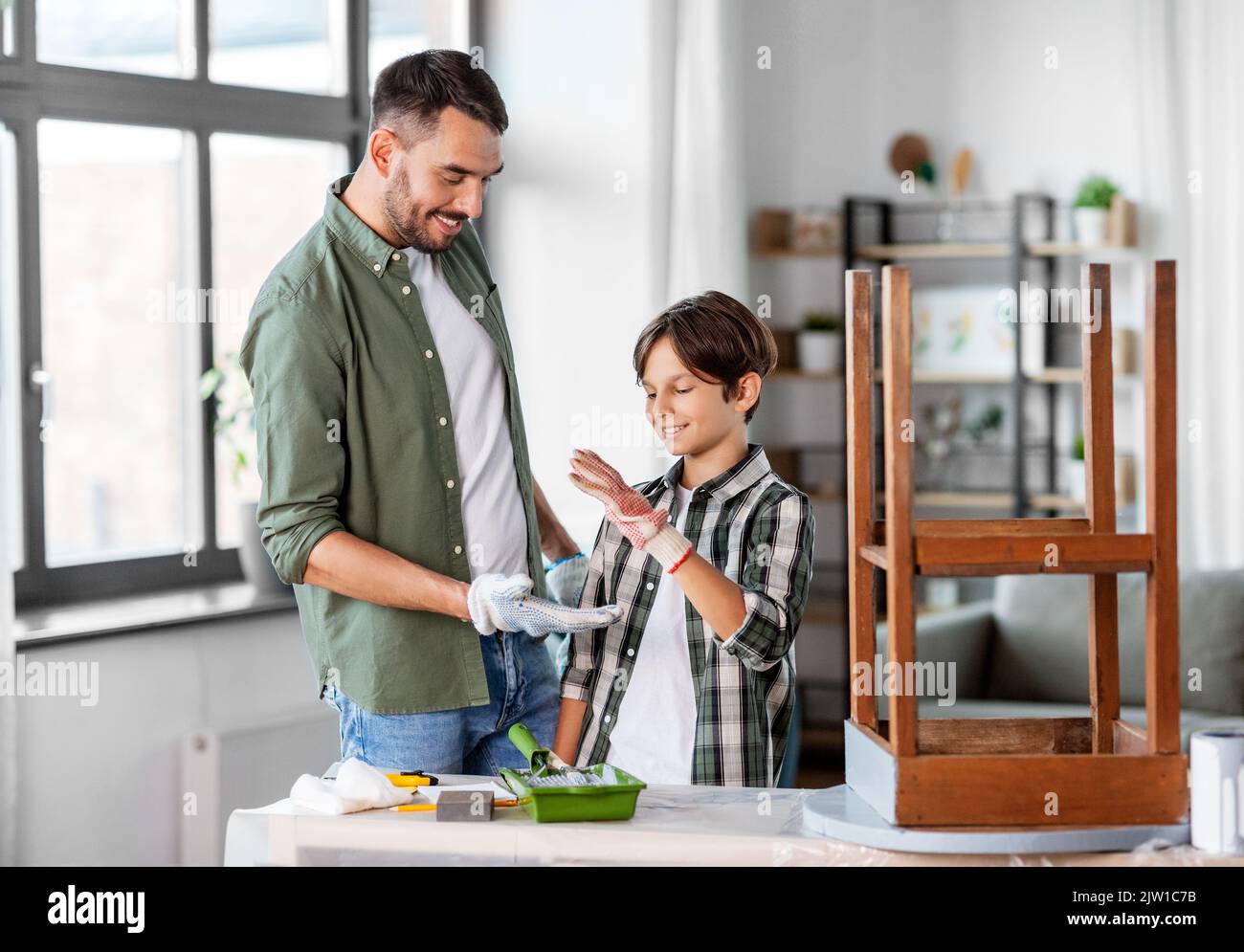 father and son making low five and restore table Stock Photo - Alamy