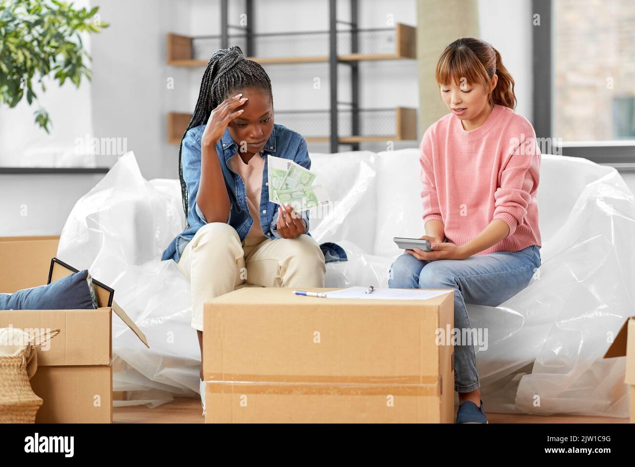women moving to new home and counting money Stock Photo - Alamy