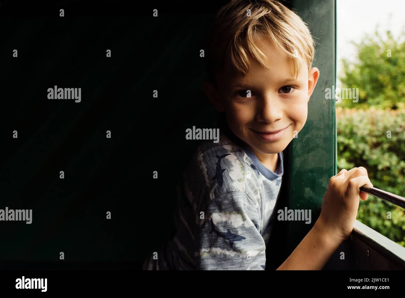 portrait of a boy smiling on a tractor ride Stock Photo - Alamy