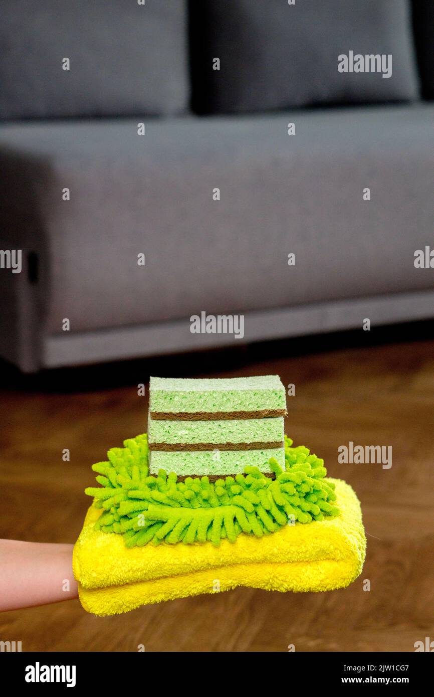 Colored rags and washcloths for manual cleaning on a woman's hand ...