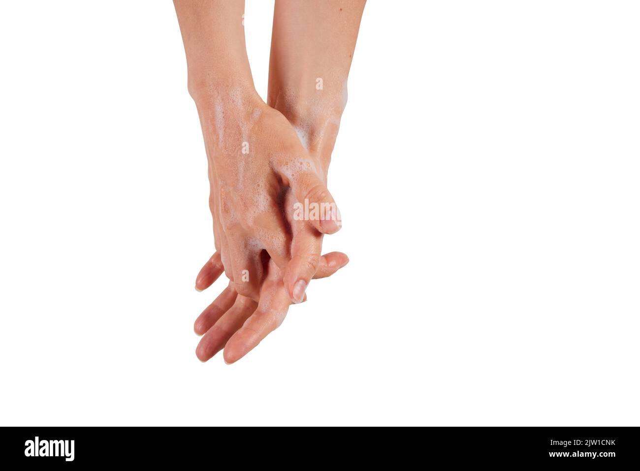 A woman clasping and rubbing hands while spreading antibacterial soap ...