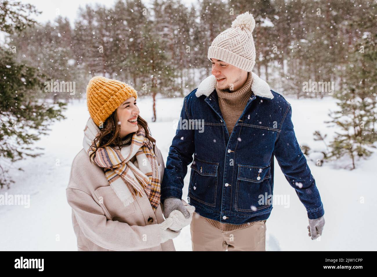 happy smiling couple walking in winter forest Stock Photo - Alamy