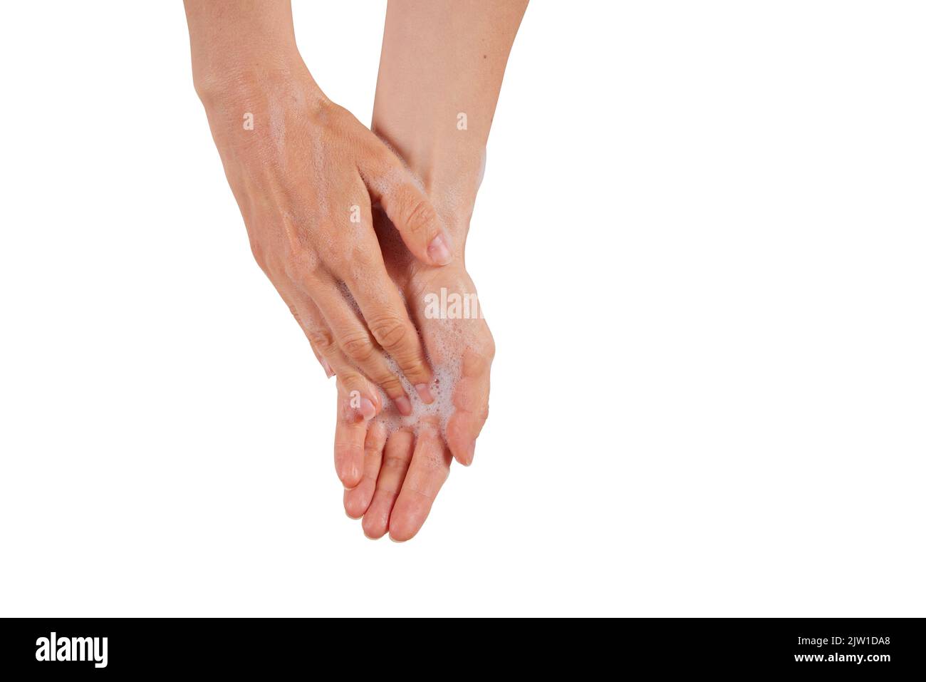 A woman lathering open palm with soap while washing hands carefully ...