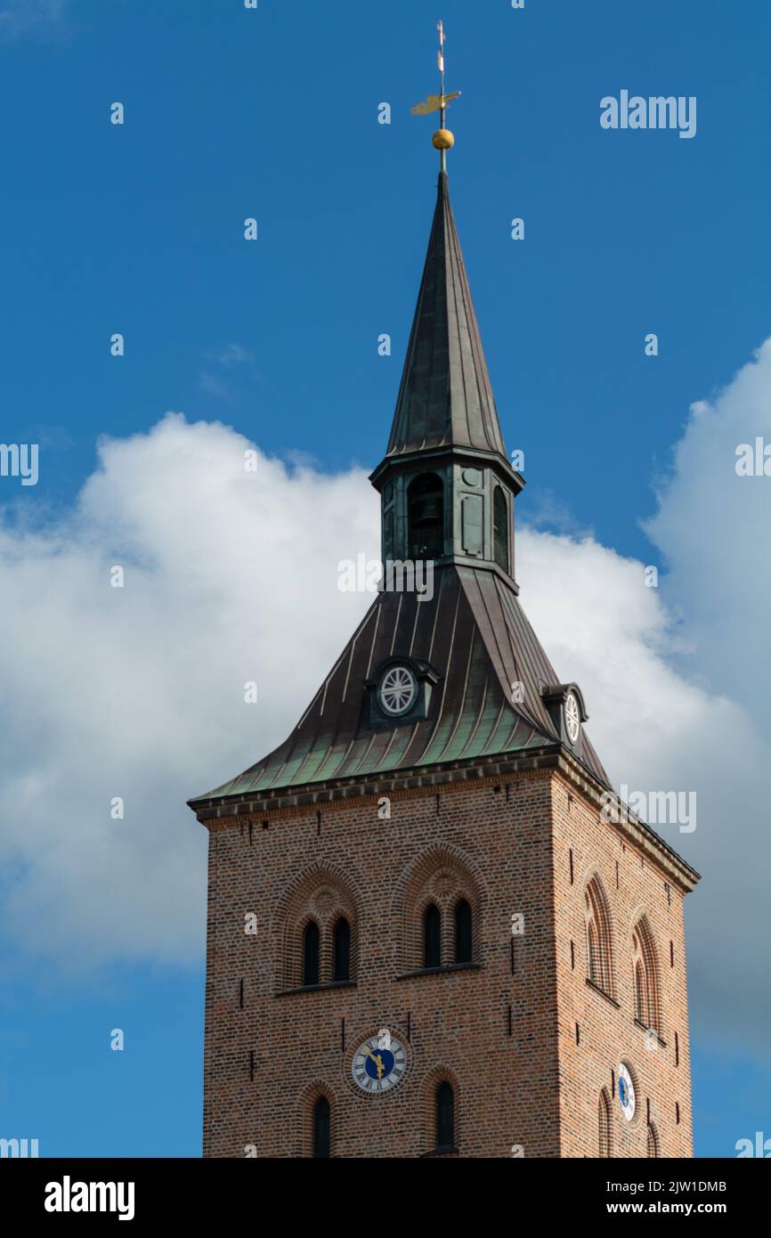 A vertical shot of the tower of Roman Catholic bishopric of Odense ...