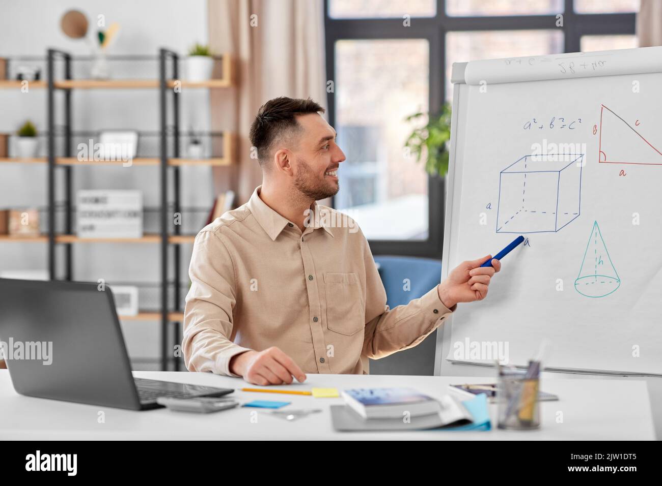 math teacher with laptop has online class at home Stock Photo - Alamy